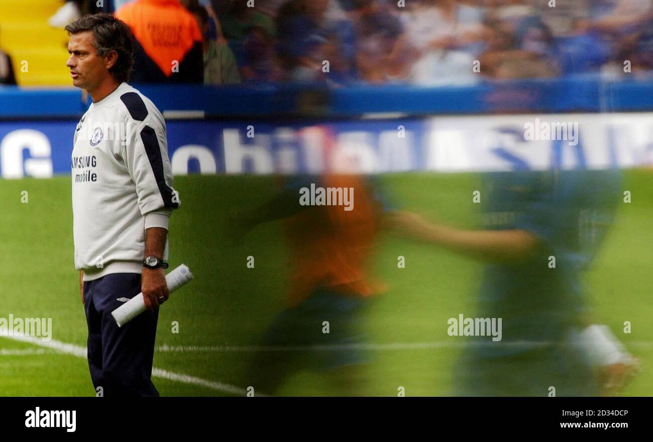 Chelsea's manager Jose Mourinho watches his players (reflected in the ...