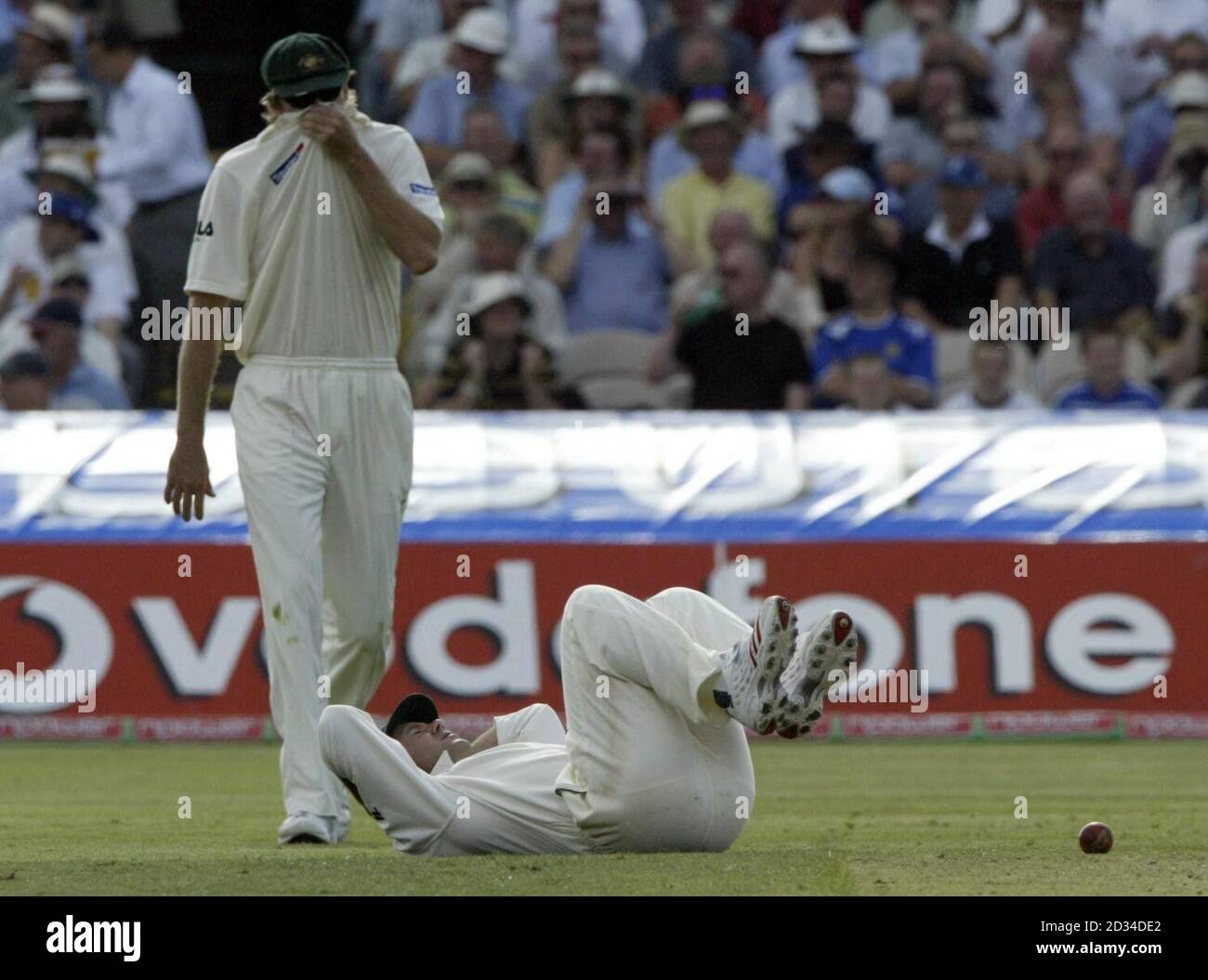 Australia's Glenn McGrath (L) trys to hide his laughter as his captain ...