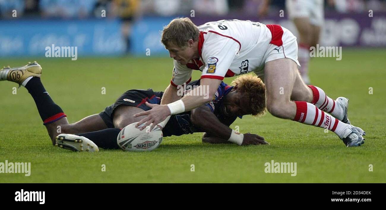 St Helens' Darren Albert (R) grabs a dropped ball from Wakefield's Semi ...