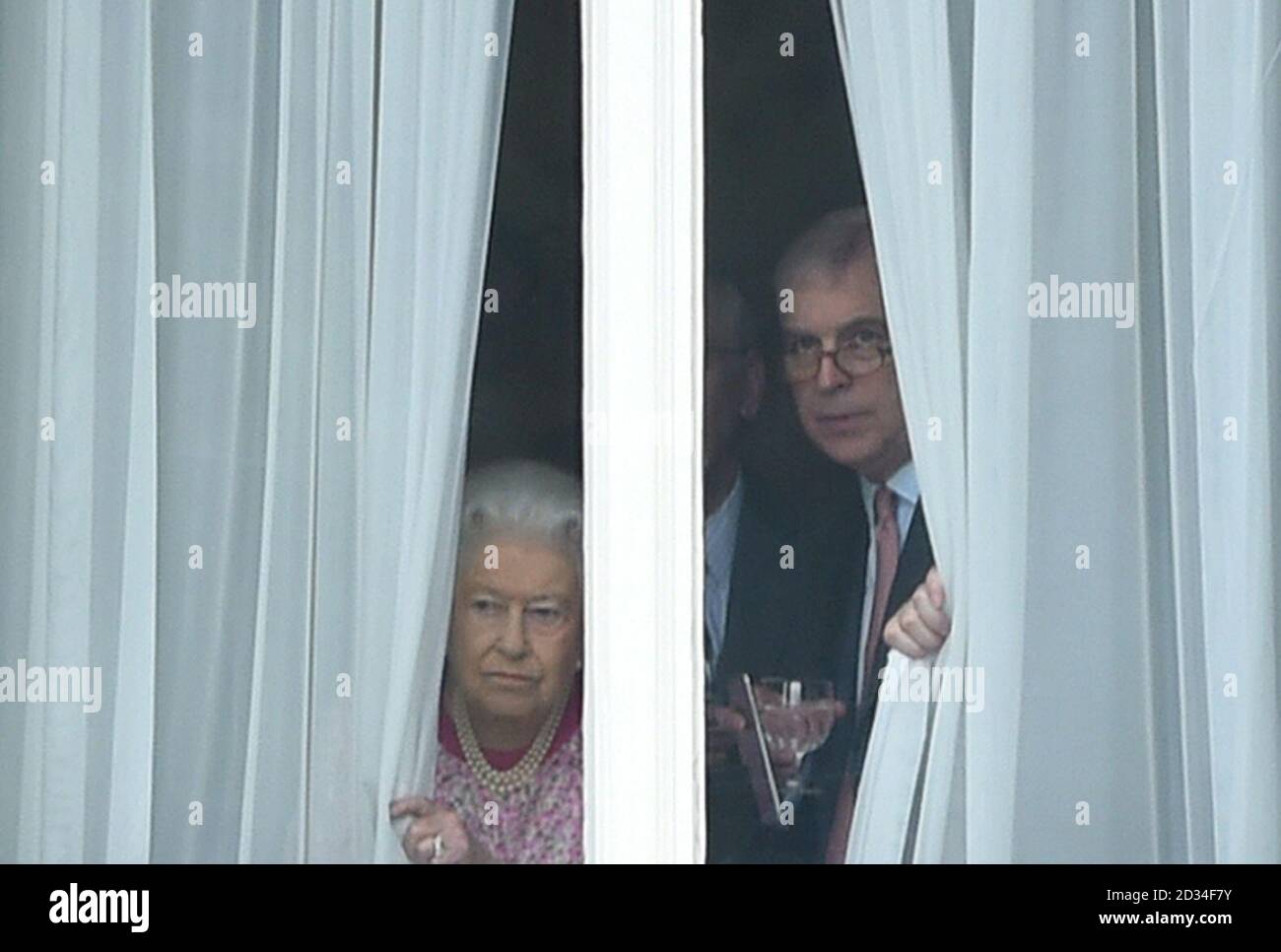 Queen Elizabeth II and the Duke of York look out from the window at ...