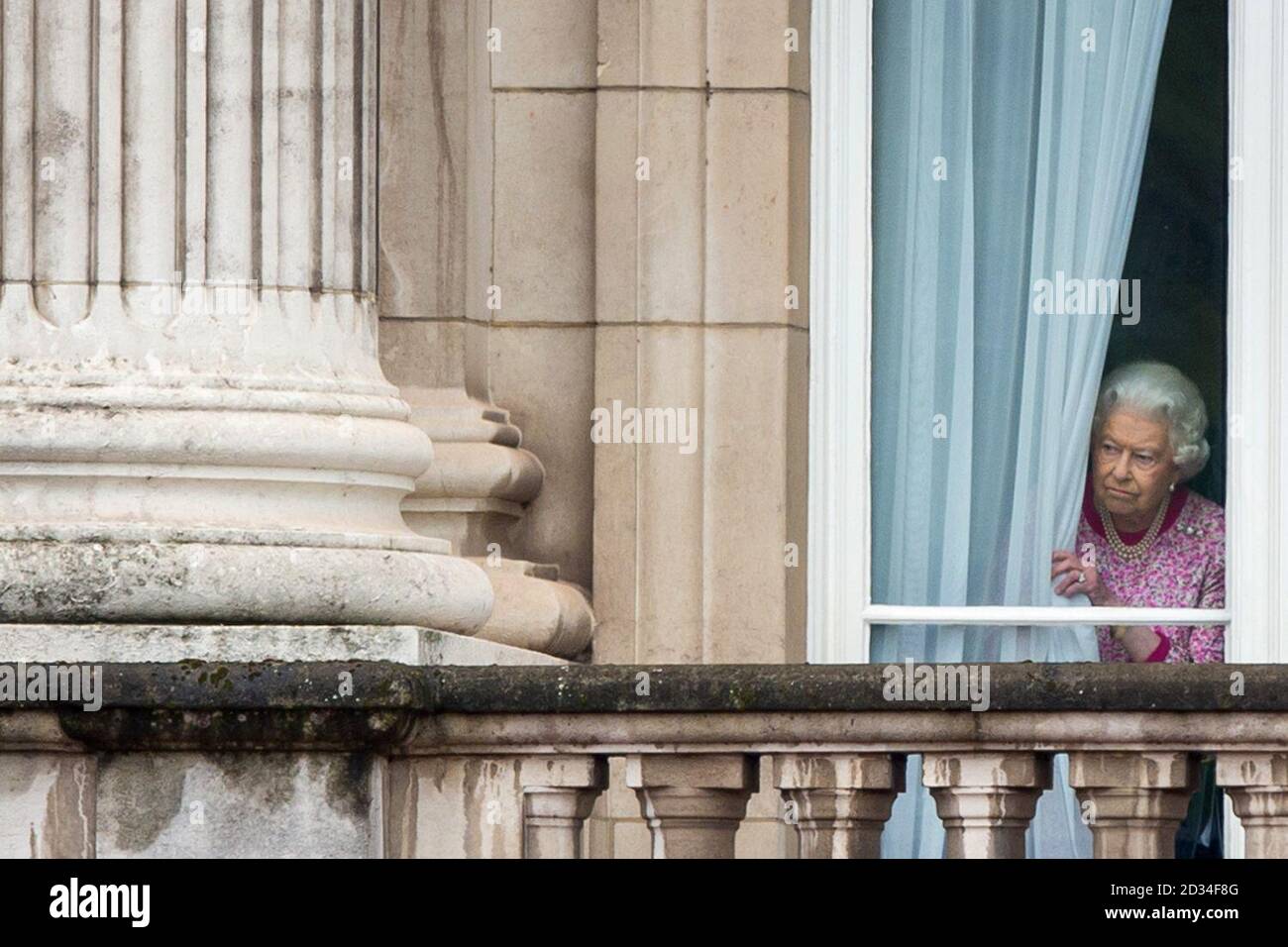 Queen Elizabeth II looks out of the window of Buckingham Palace, in ...
