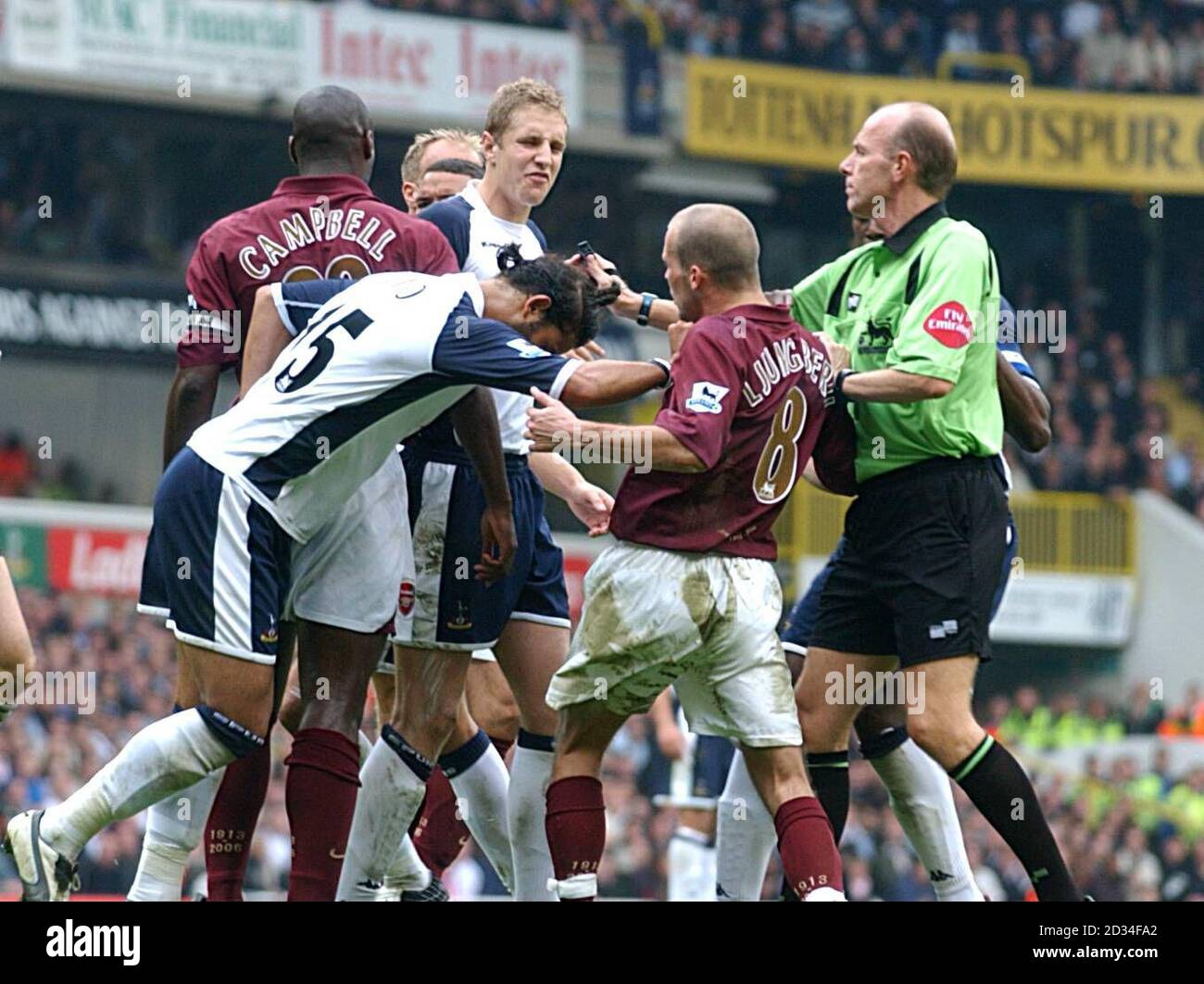 Referee Steve Bennett tries to calm down both sides after tempers flare ...