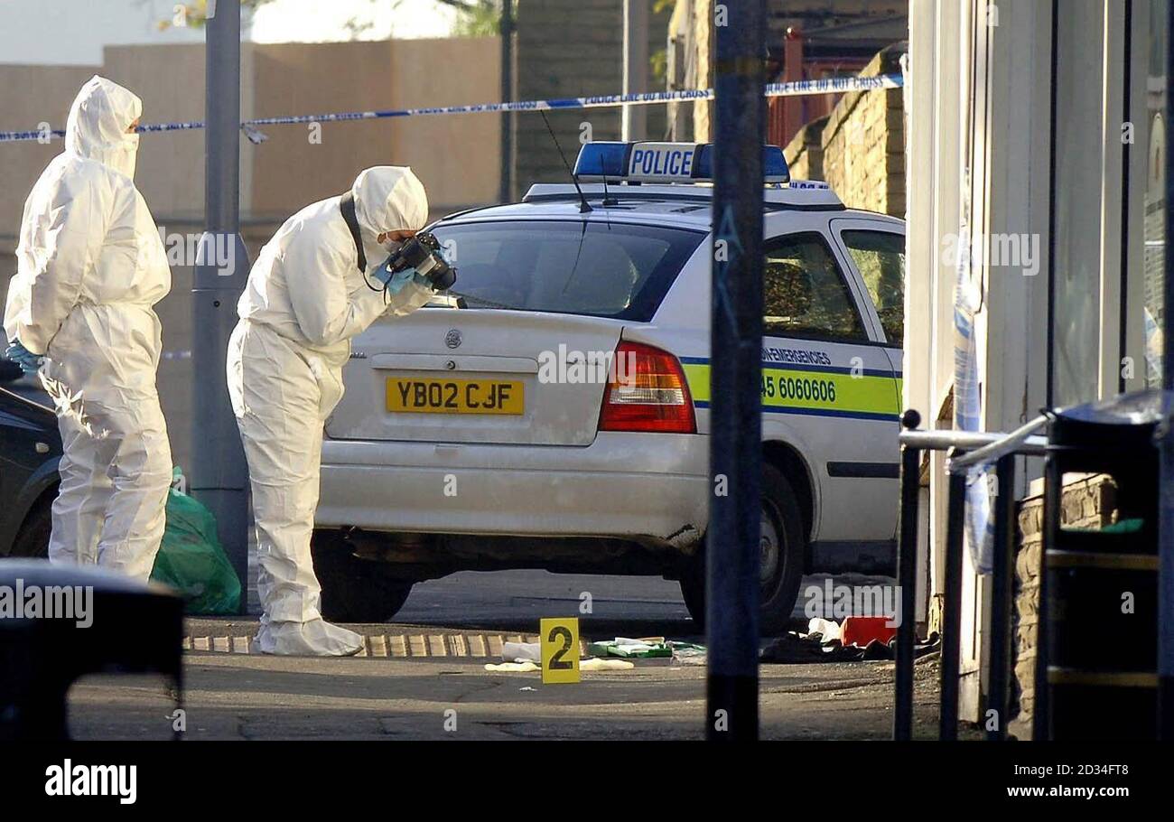 Forensic teams examine police patrol car used hi-res stock photography ...