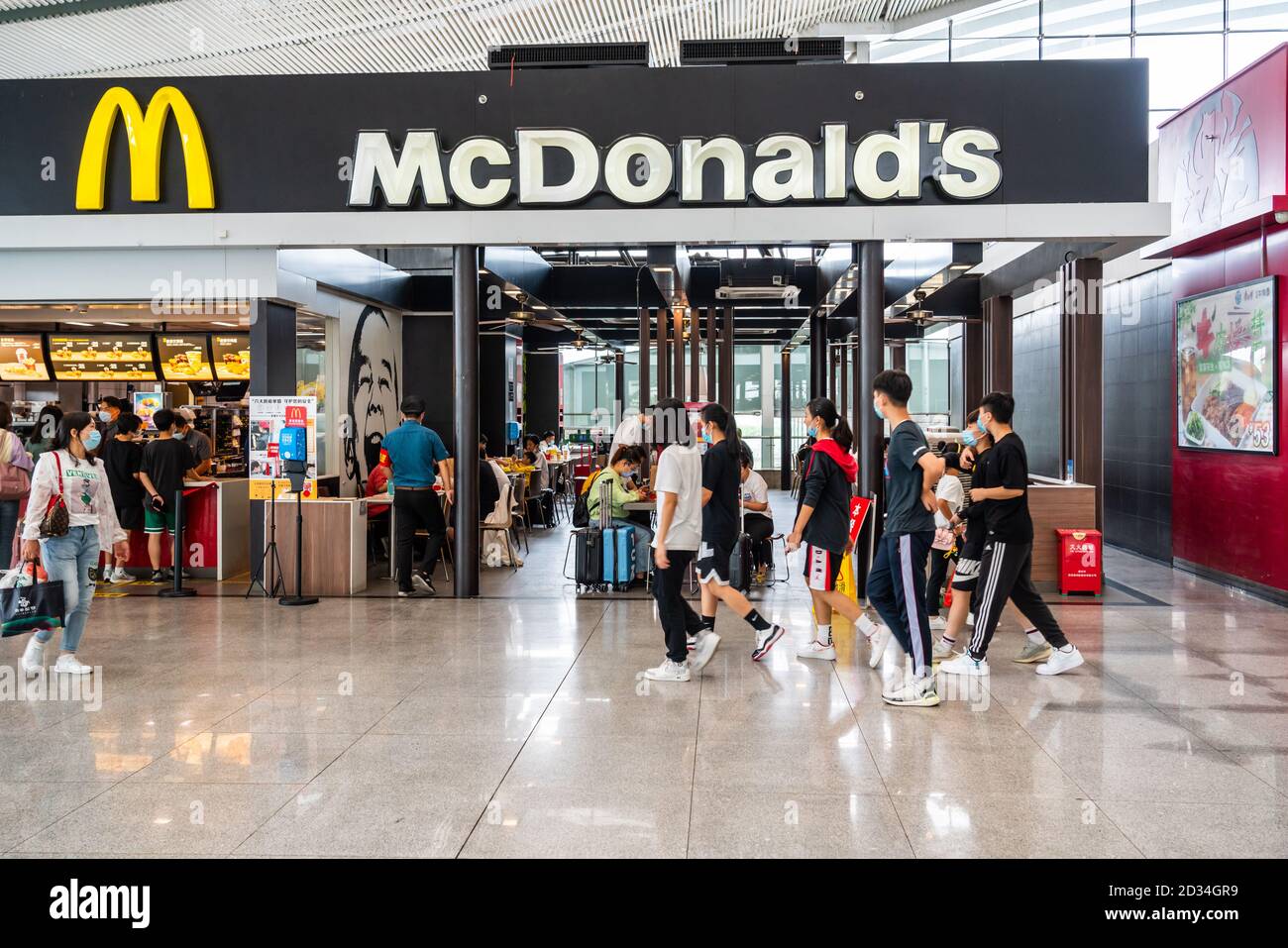 Pedestrians walk past a McDonald's fast food restaurant in Shenzhen ...