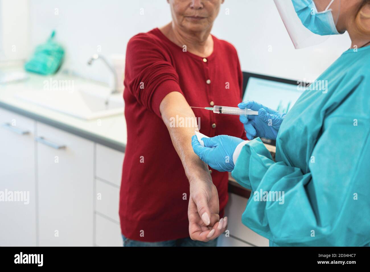 Senior woman injection arm hi-res stock photography and images - Alamy