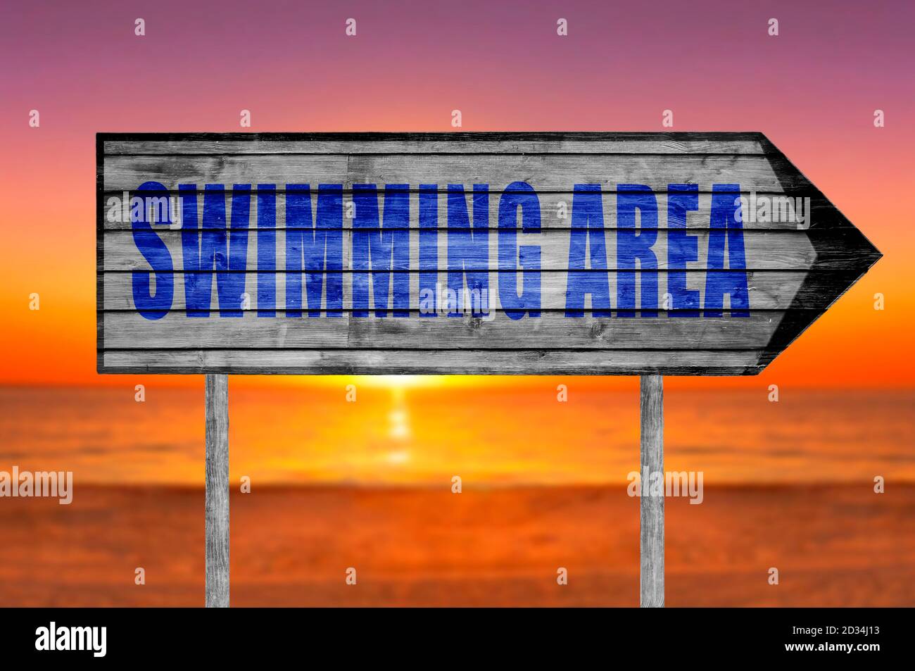 Beach Swimming Area wooden sign with a beach on background Stock Photo ...