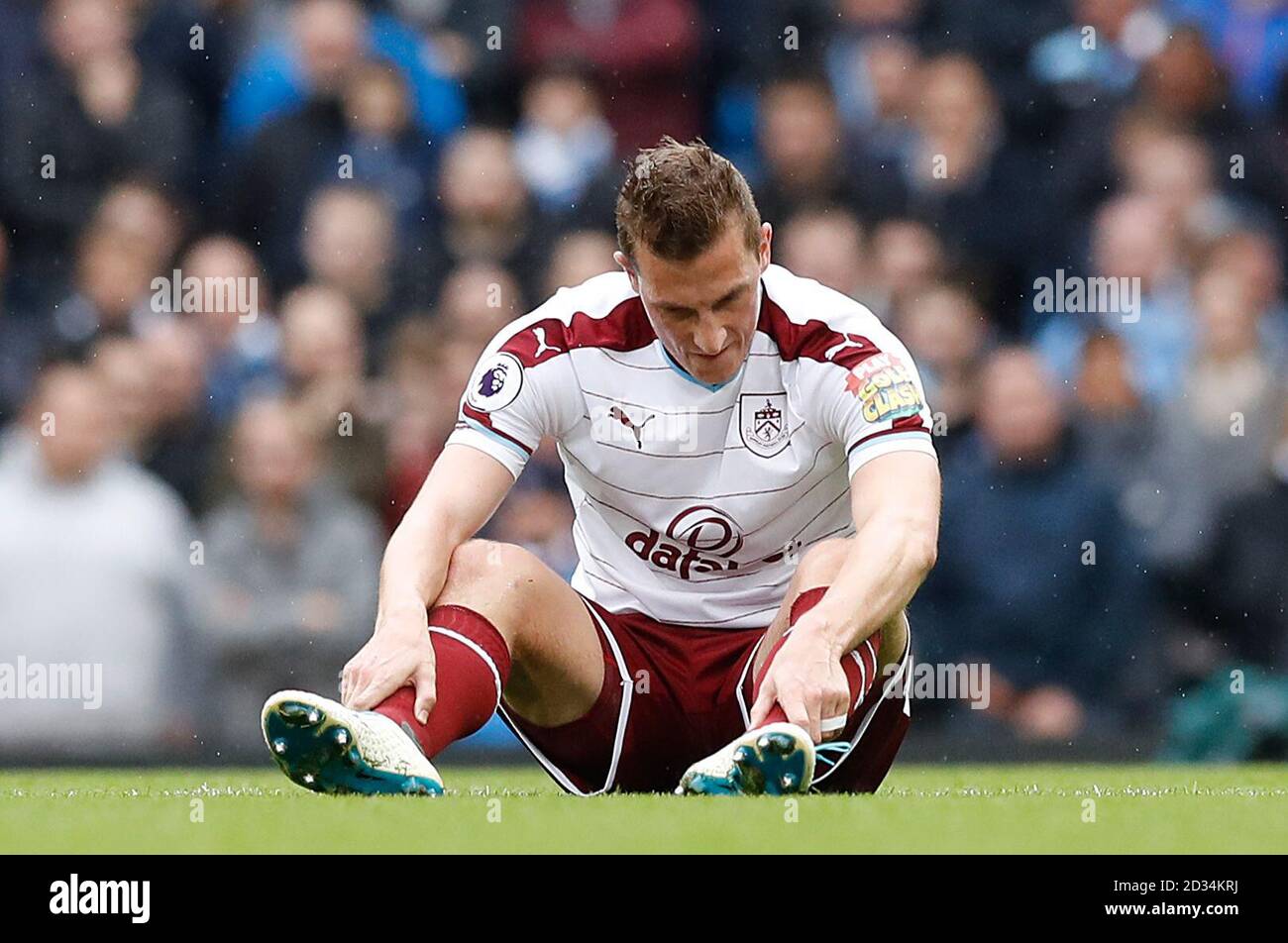 Burnley's Chris Wood sits injured during the Premier League match at ...