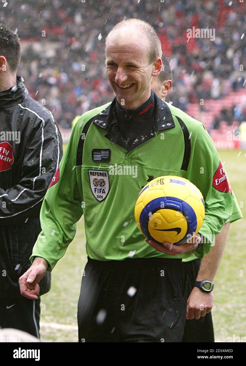 Referee Mike Riley leaves the pitch after calling the game off Stock ...