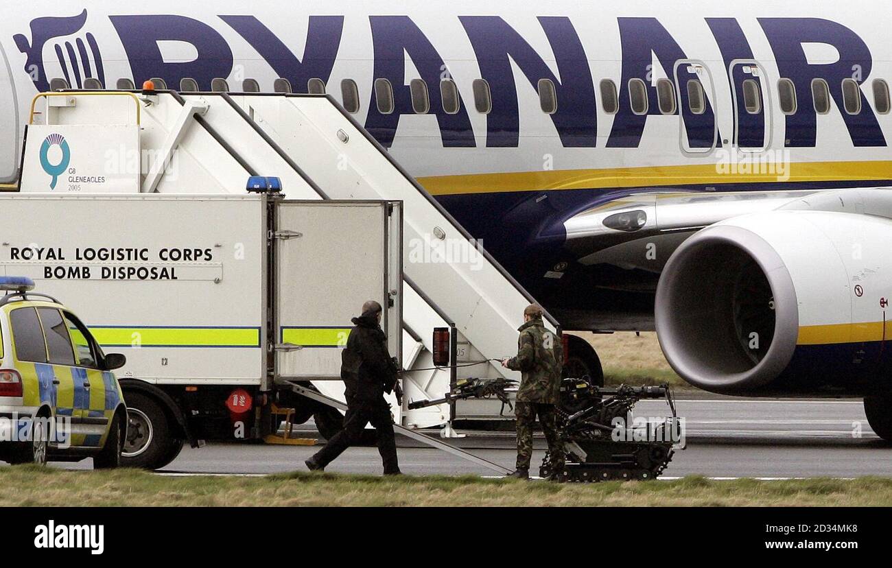 A bomb disposal unit team arrive with armed police (black jacket) at ...