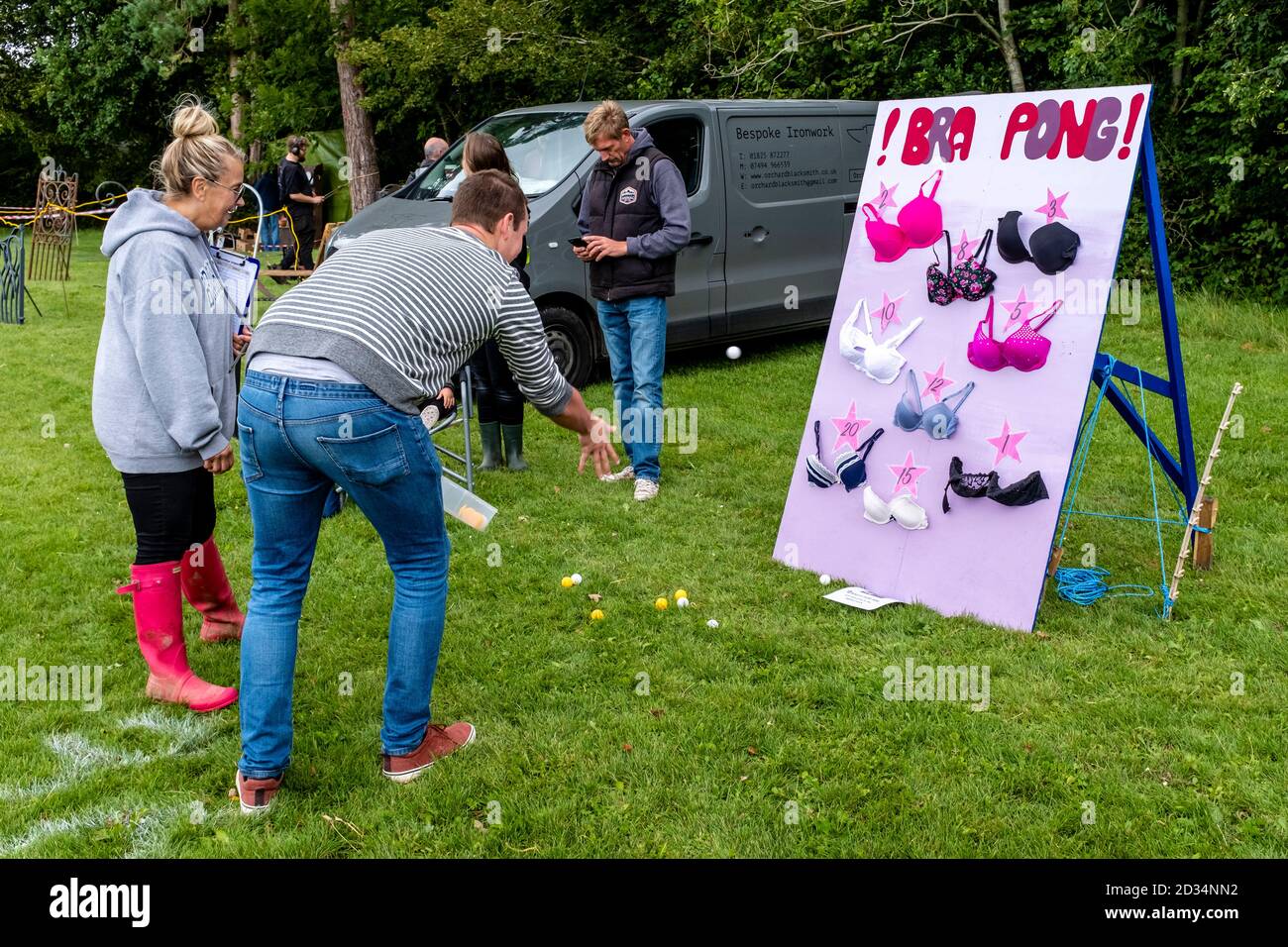 Local People Play A ‘Bra Pong’ Game Where They Throw Plastic Balls Into ...
