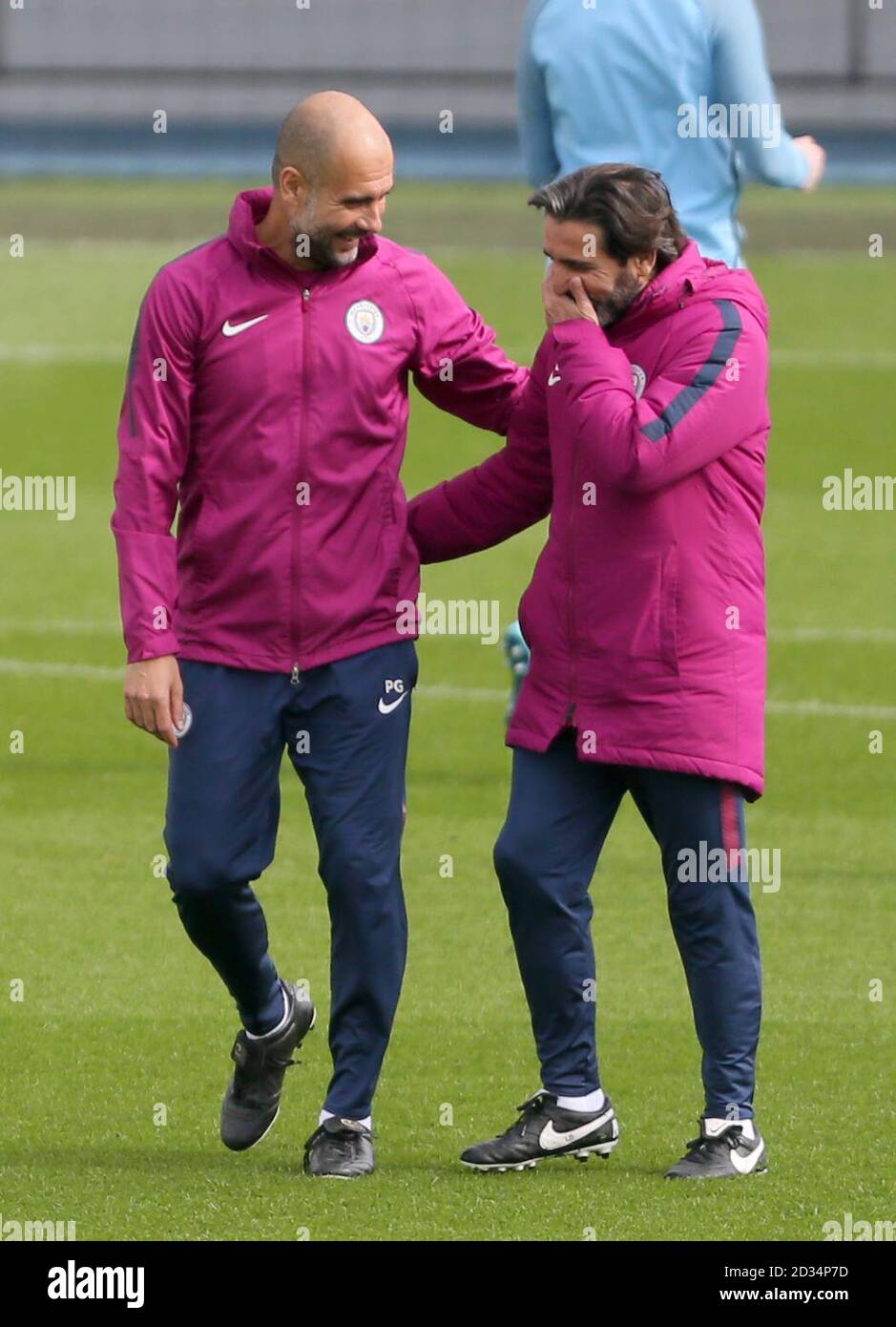 Manchester City manager Pep Guardiola (left) shares a joke with fitness ...