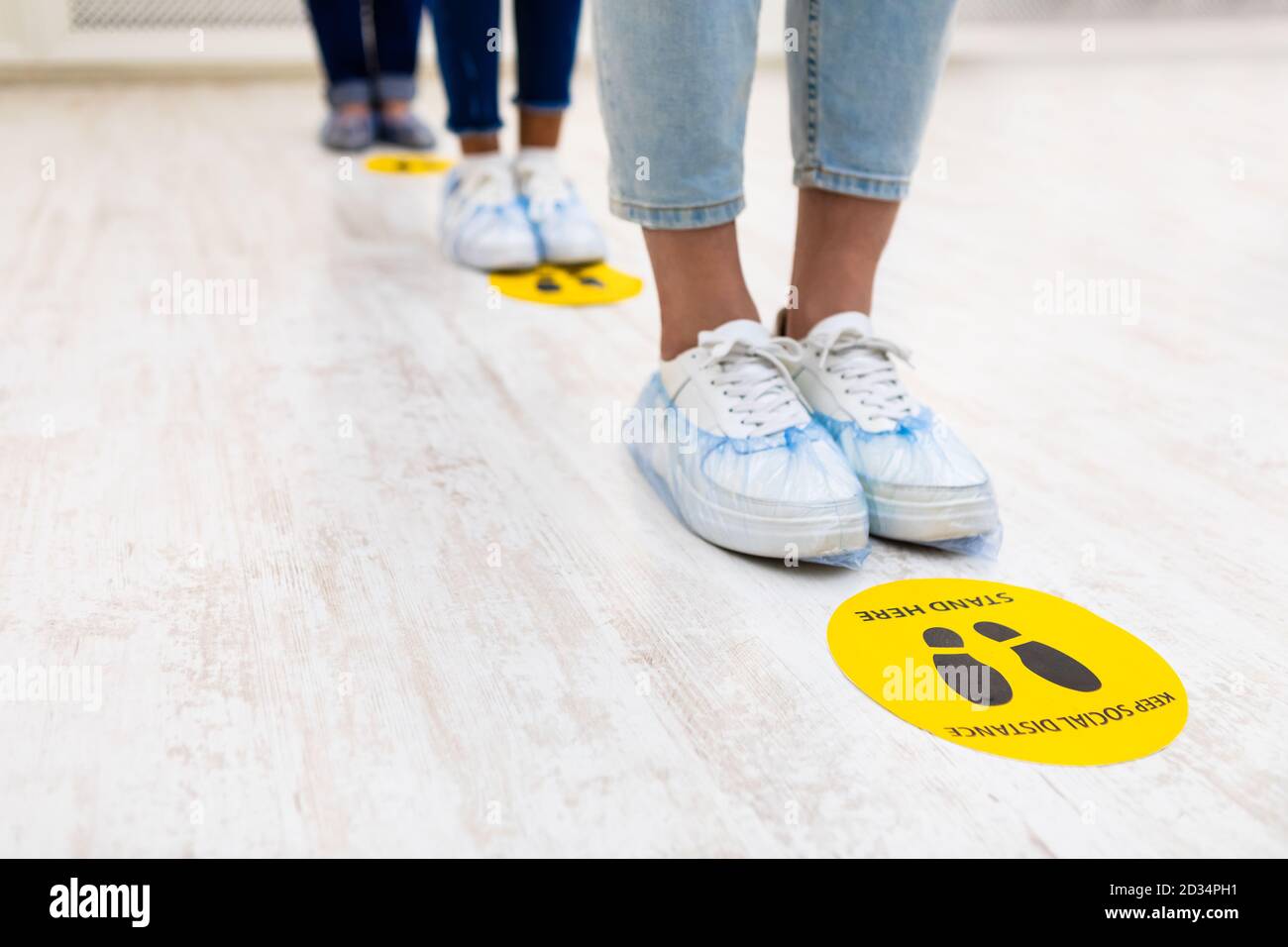People Standing In Queue, Social Distancing Signs On Floor Indoors ...
