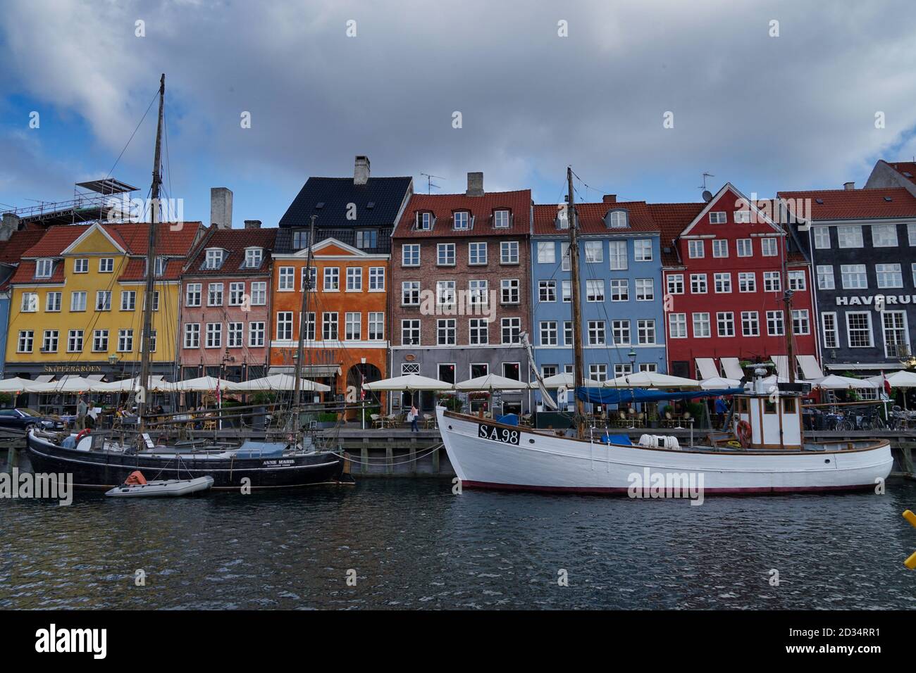 Copenhagen, Europe, colored houses in Nyhavn, promenade and moored ...