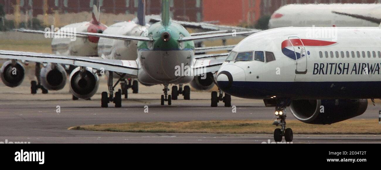 A British Airways (BA) jet taxis into Terminal One, while other ...