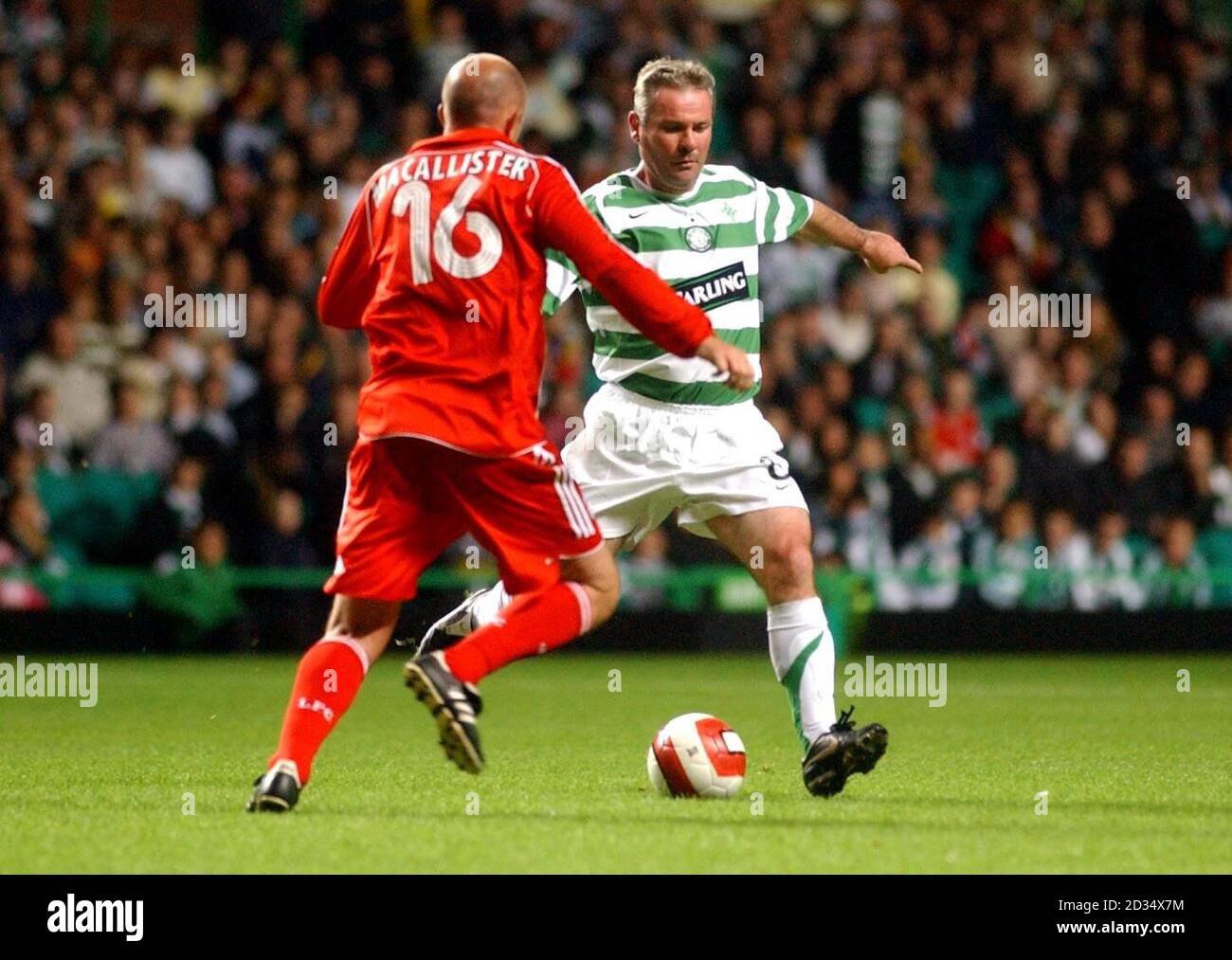 Celtic Legends' Brian McClair is challenged by Liverpool Legends' Gary ...