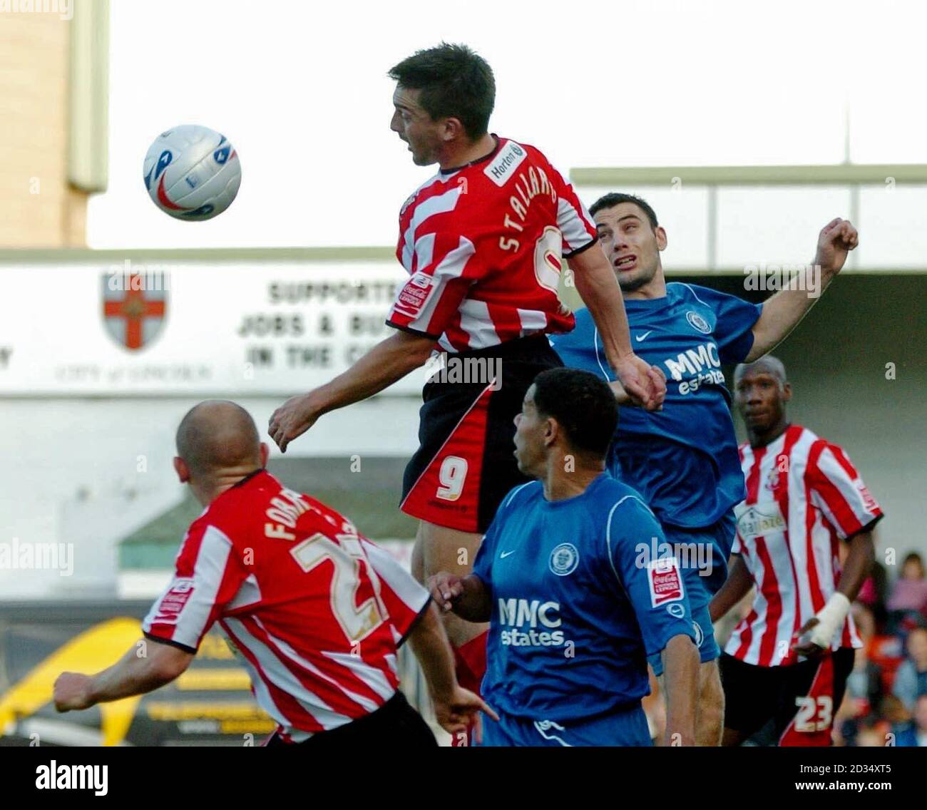Lincoln's Mark Stallard (centre) climbs highest in a clash in the ...