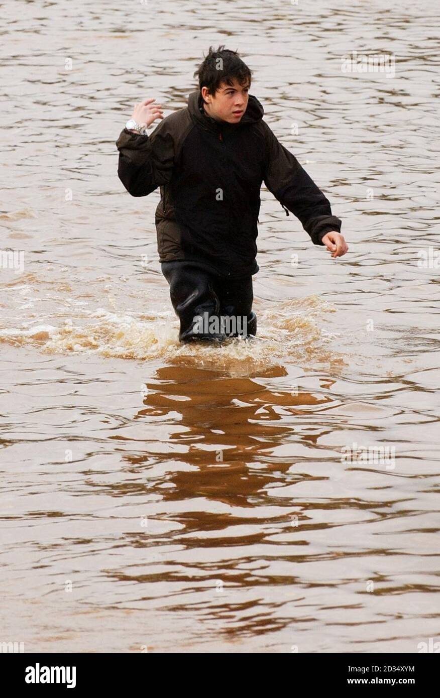 A local wades through water following flooding in Dingwall near ...