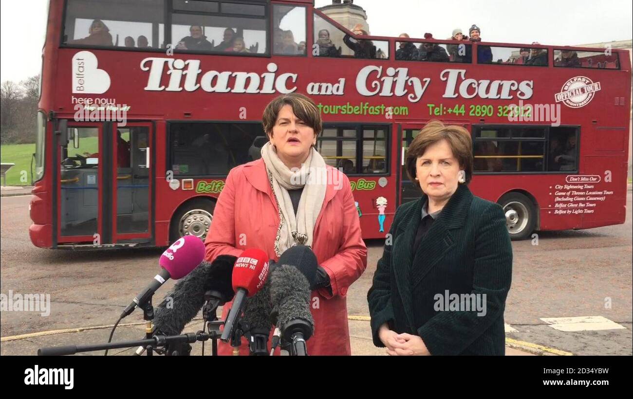 A tour bus passes behind DUP leader Arlene Foster (left) and party MEP ...
