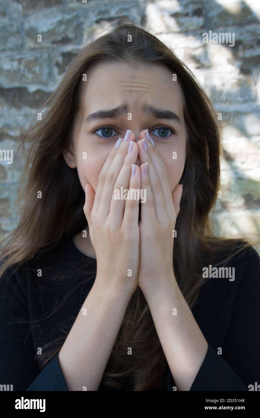 Frightened frustrated young beautiful girl with long blond hair on the ...