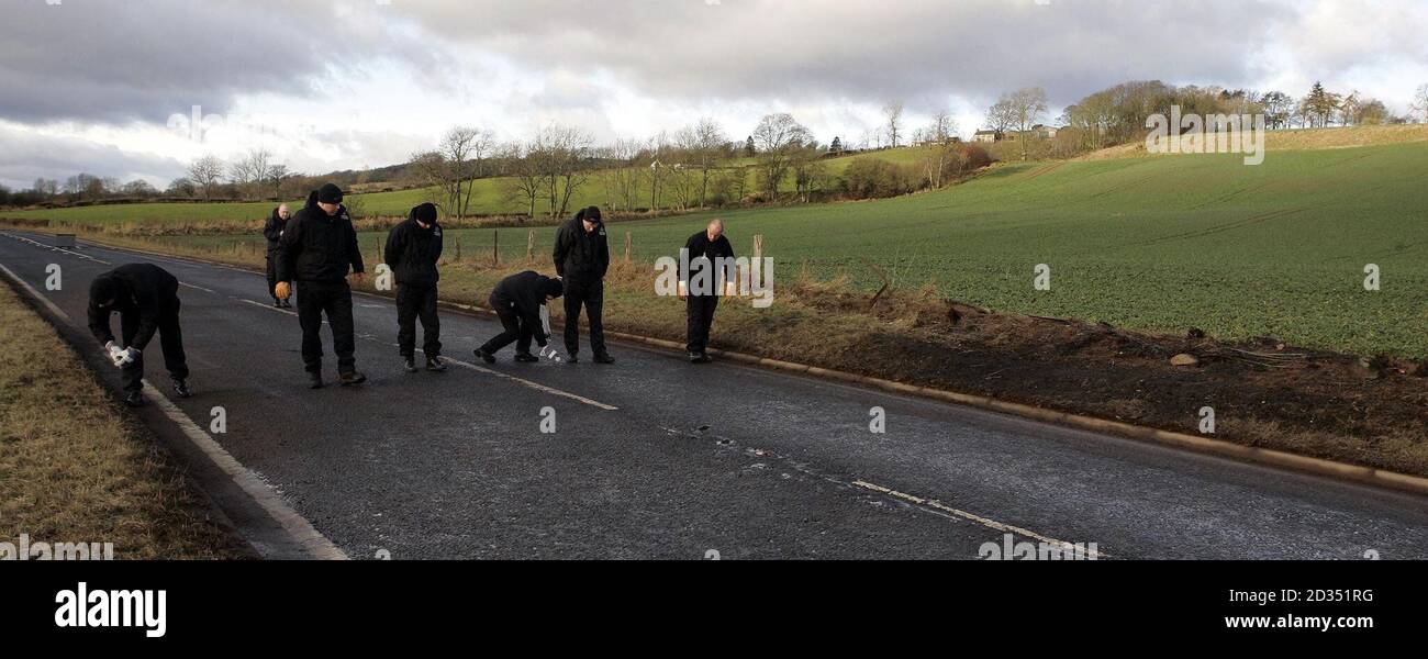 Tayside Police officers search for clues at the scene of the road crash ...