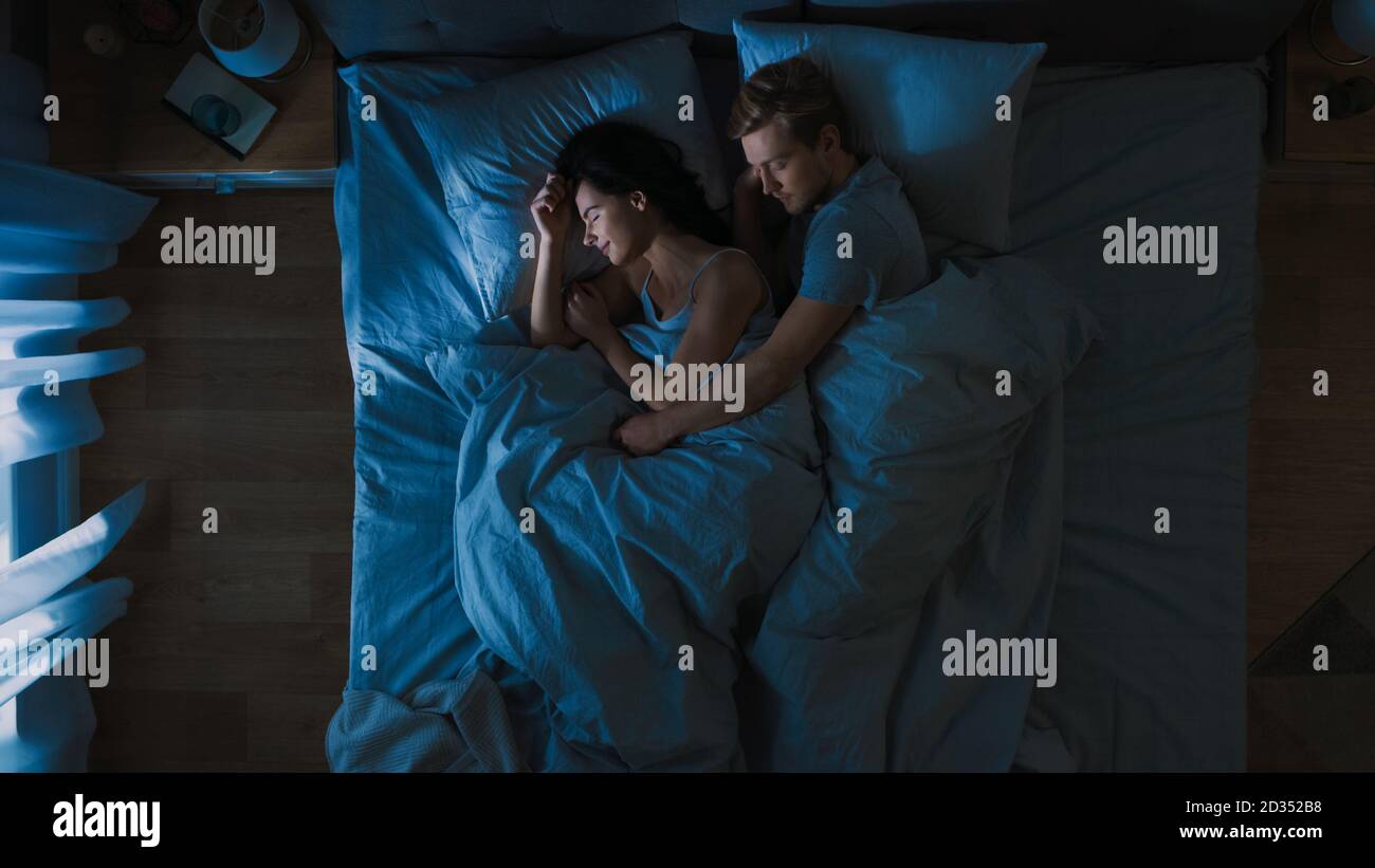 Top View Bed at Night: Attractive young Couple Sleeping Together ...
