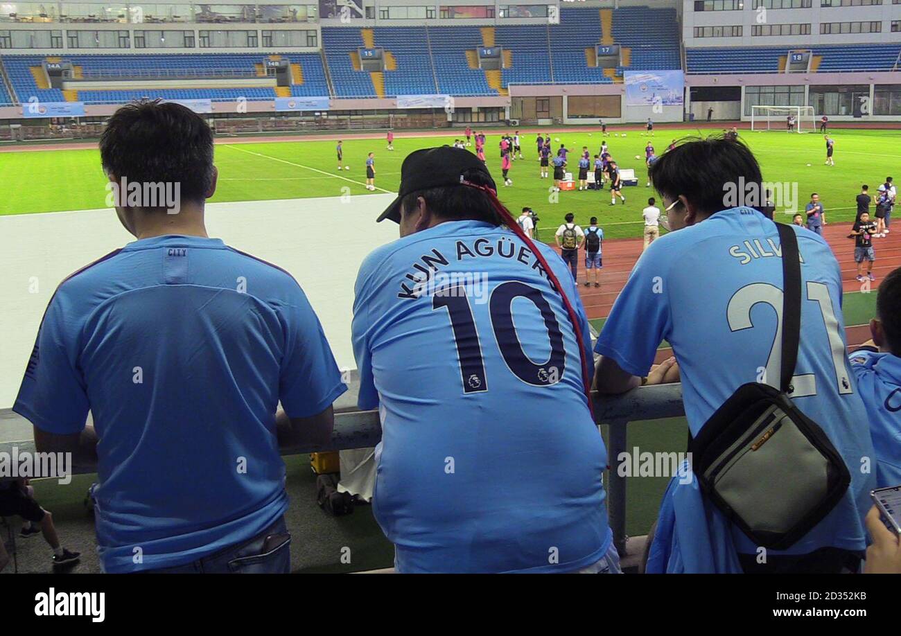 Fans watch the Manchester City training session at the Yuanshen Stadium ...