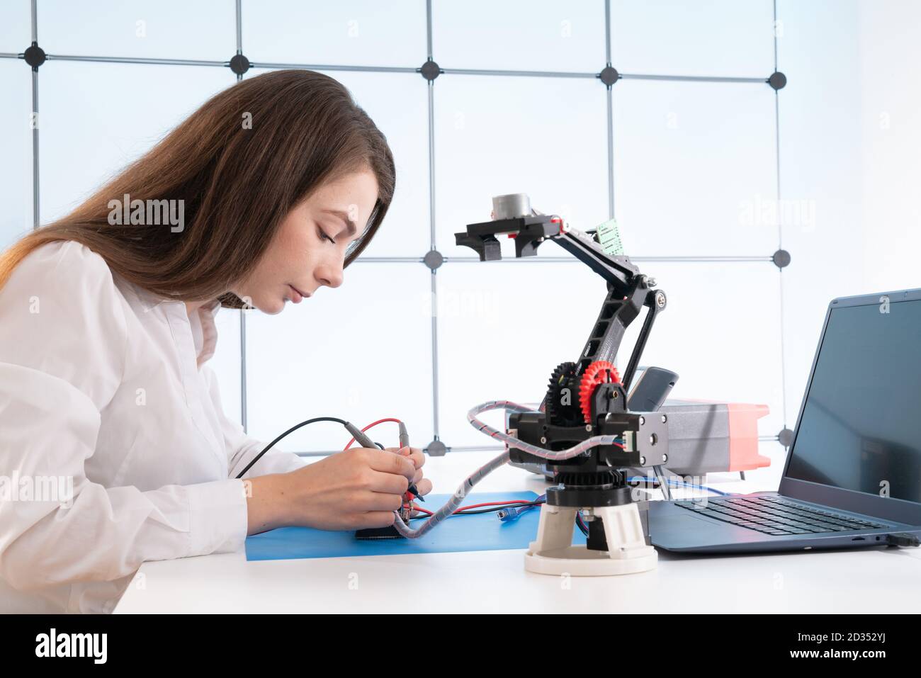 Woman student with industrial robot arm in designer laboratory Stock ...