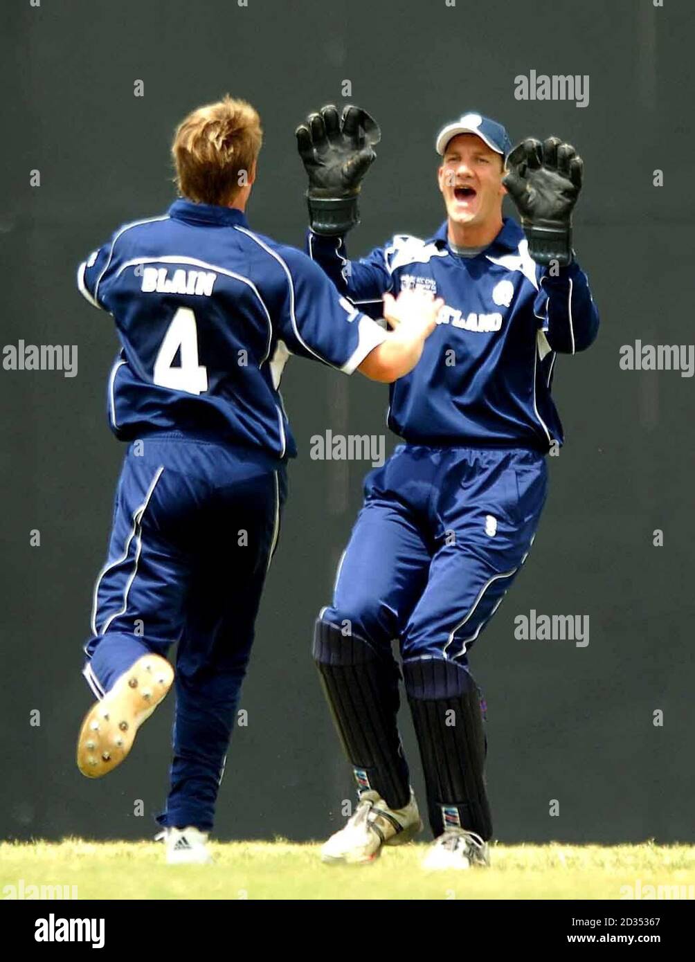 Scotland's John Blain (left) and wicketkeeper Colin Smith celebrate the ...