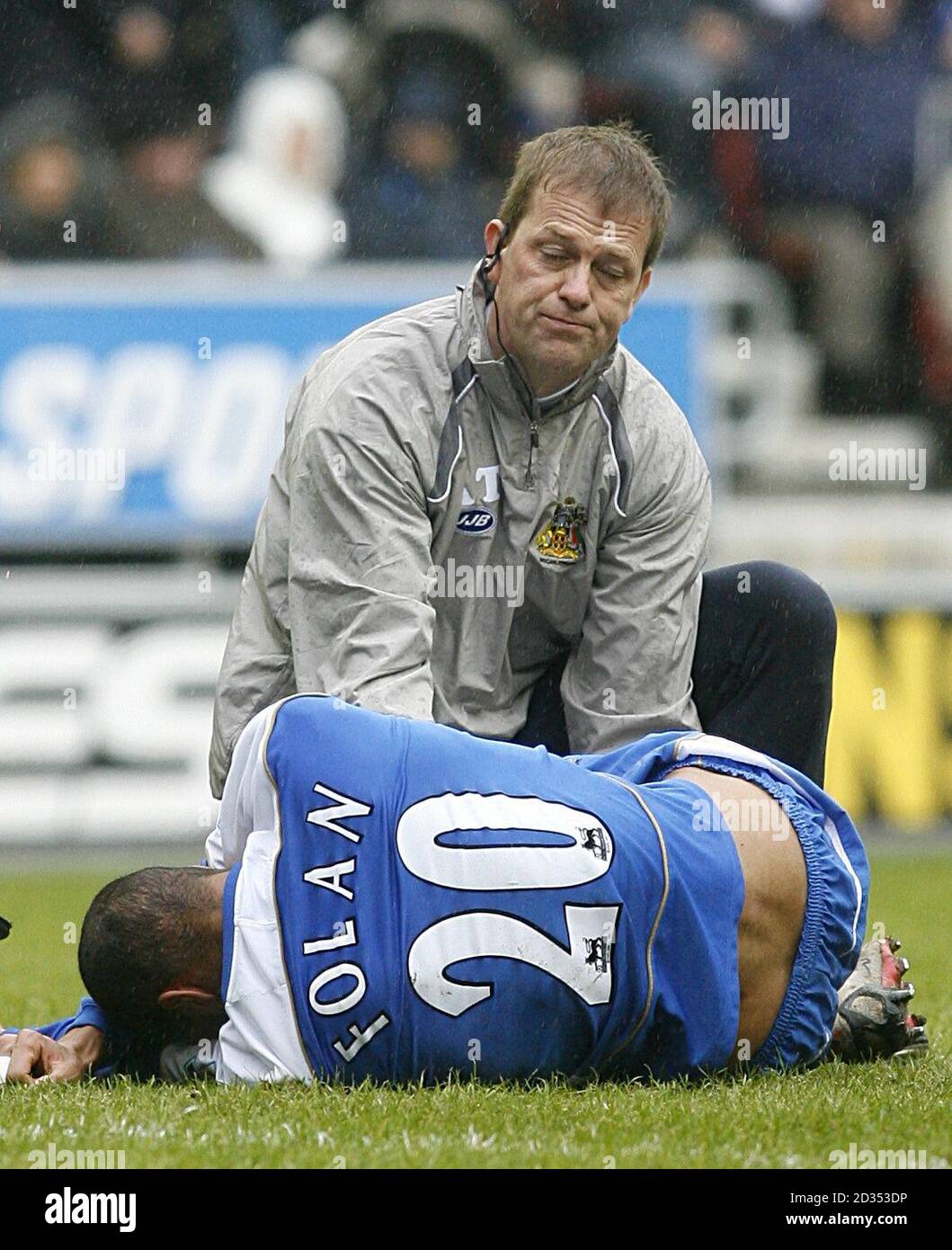 Wigan Athletic's Caleb Folan recieves treatment after a challenge by ...