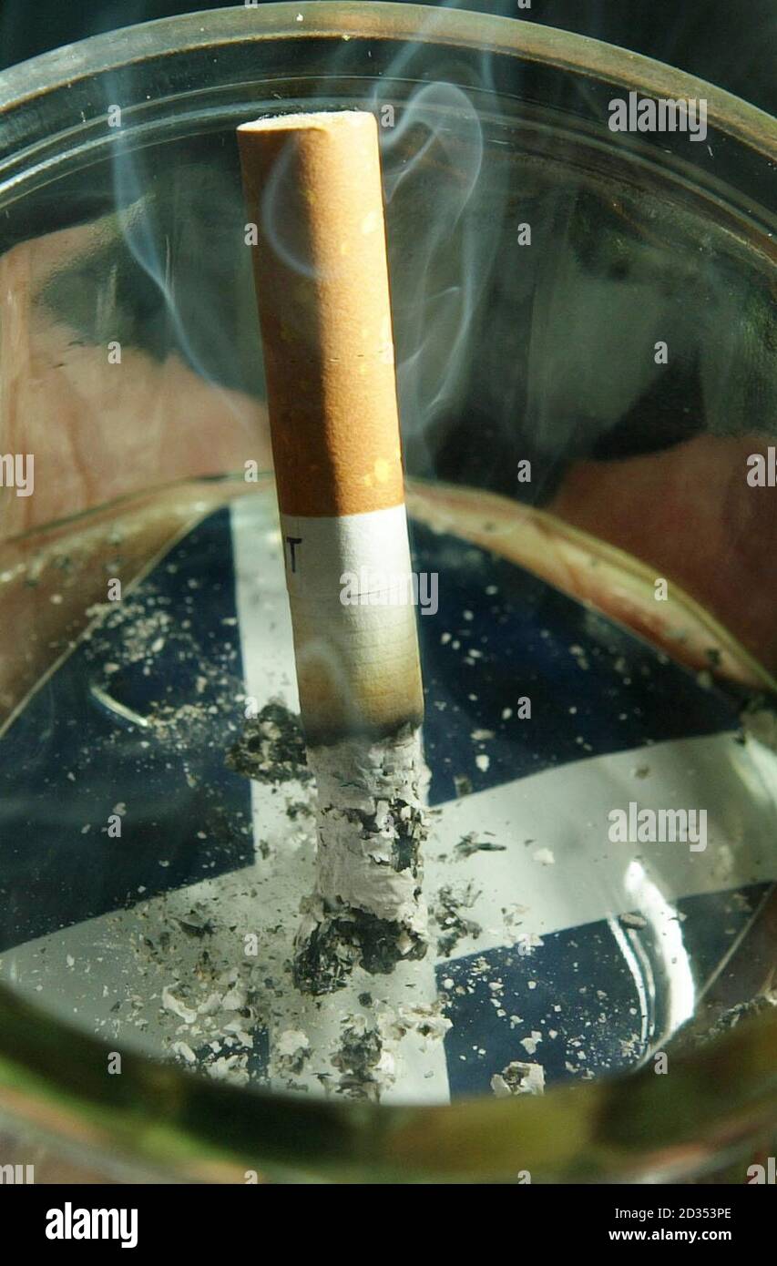 A cigarette burns in an ashtray on the one year anniversary of the ...