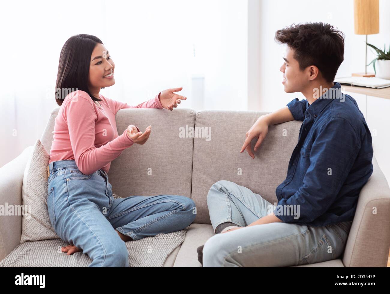 Couple flirting on sofa hi-res stock photography and images - Alamy