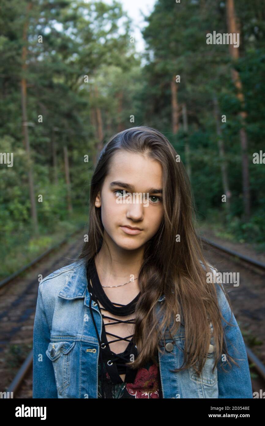 Portrait of trendy beautiful serious long haired blond teenage girl ...