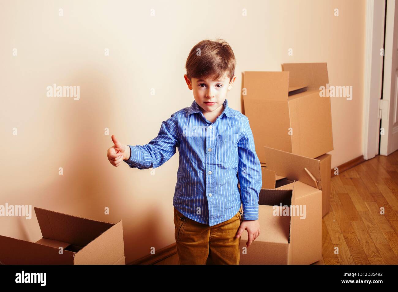 little cute boy in empty room, move to new house. home alone among ...