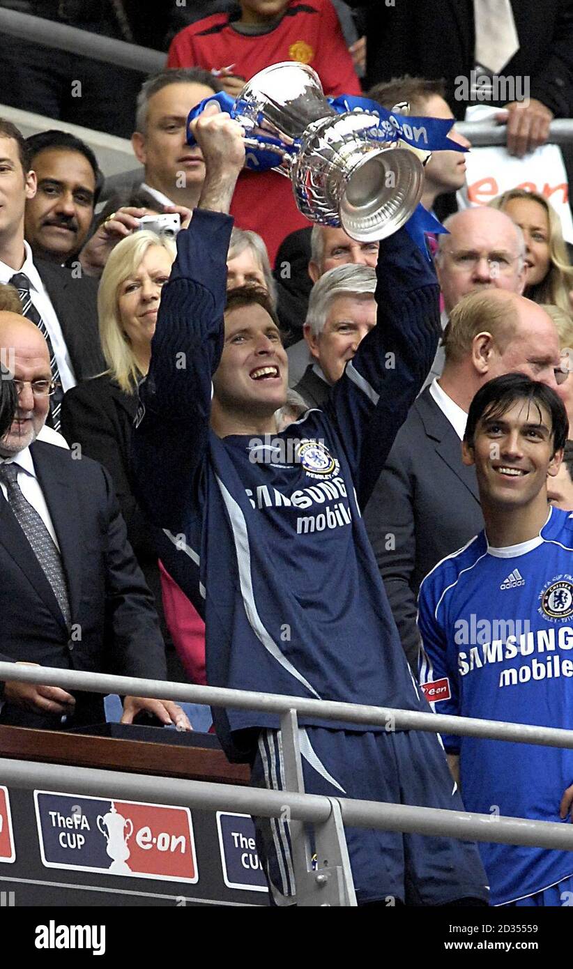 Chelsea goalkeeper Petr Cech lifts the FA Cup trophy after winning the ...