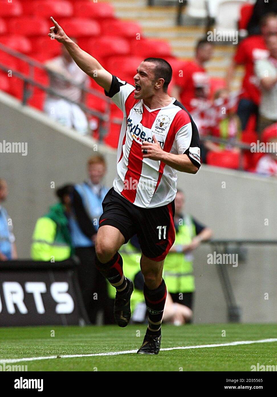 Exeter City's Lee Phillips (left) celebrates scoring the first goal of ...