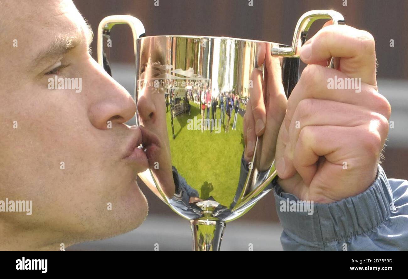 Winning male Ian Grime kisses his trophy after completing the Edinburgh ...