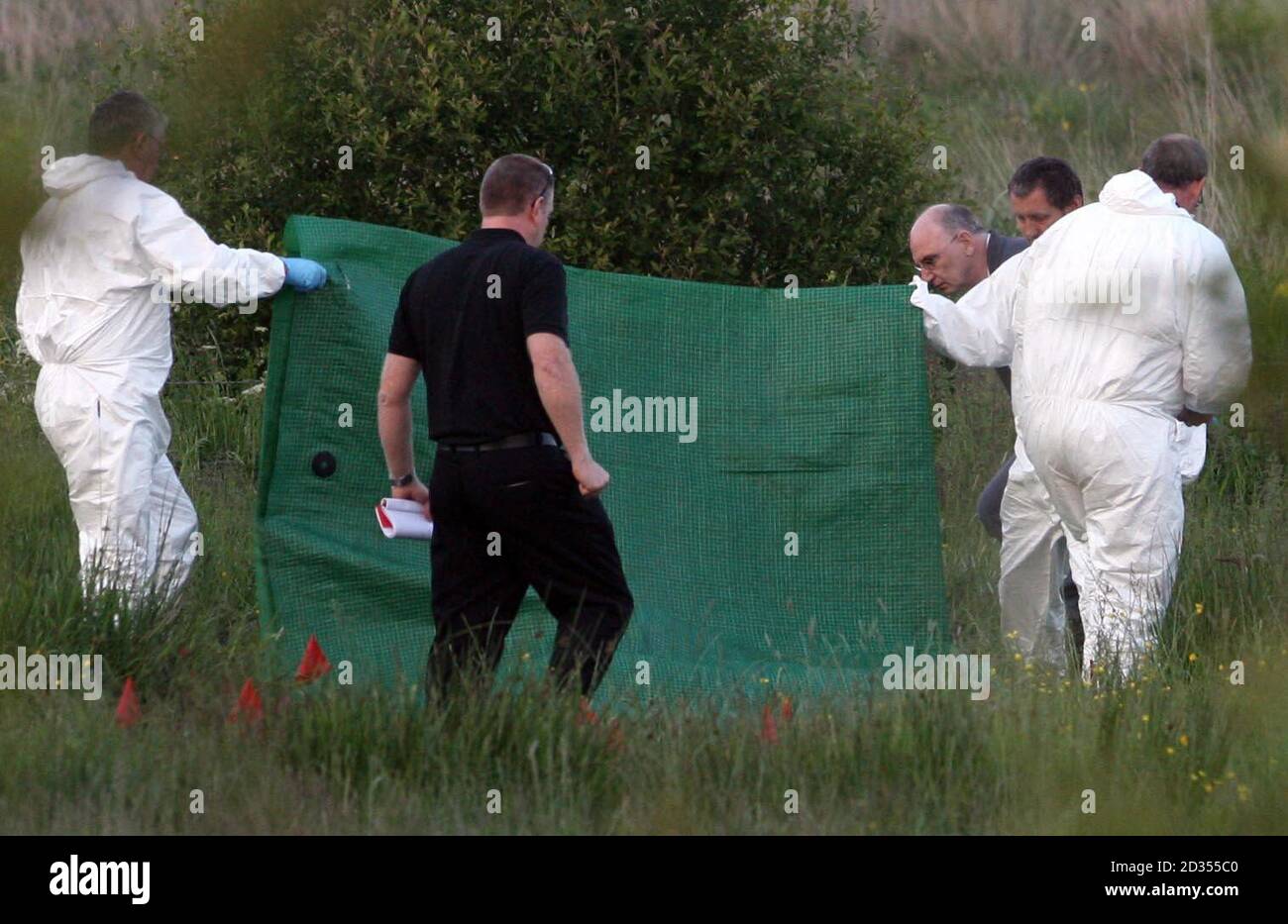 Dr Stephen Leadbeatter (third from the right) examines a body close to ...
