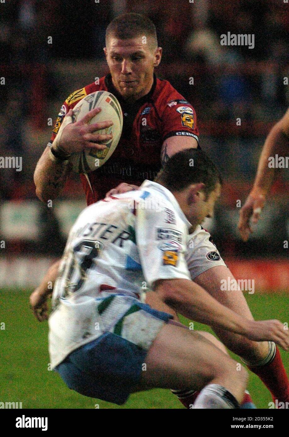 Salford's Malcolm Alker tackled by Harlequins' Steve Bannister during ...