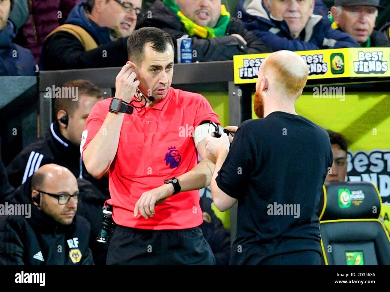 Referee Peter Bankes has his microphone pack refitted during the ...