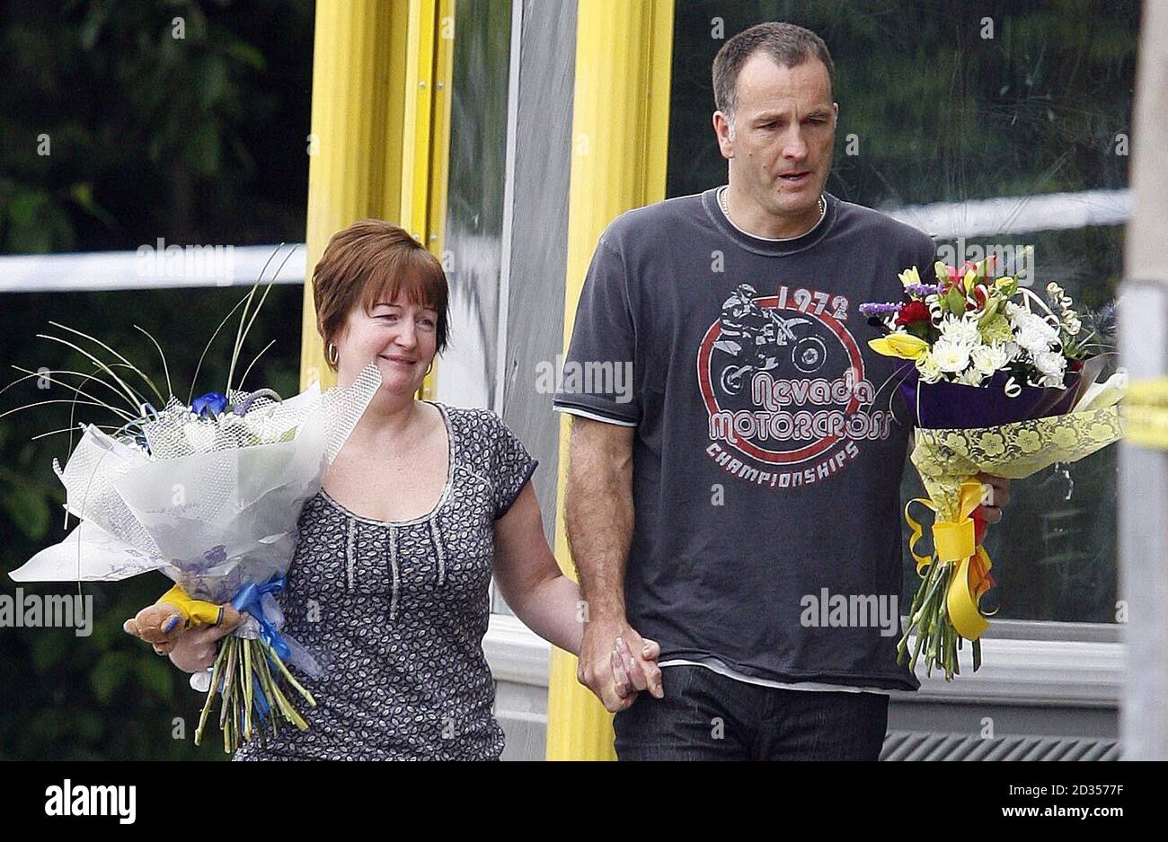 Melanie and Stephen Jones bring flowers to the scene of the shooting of ...