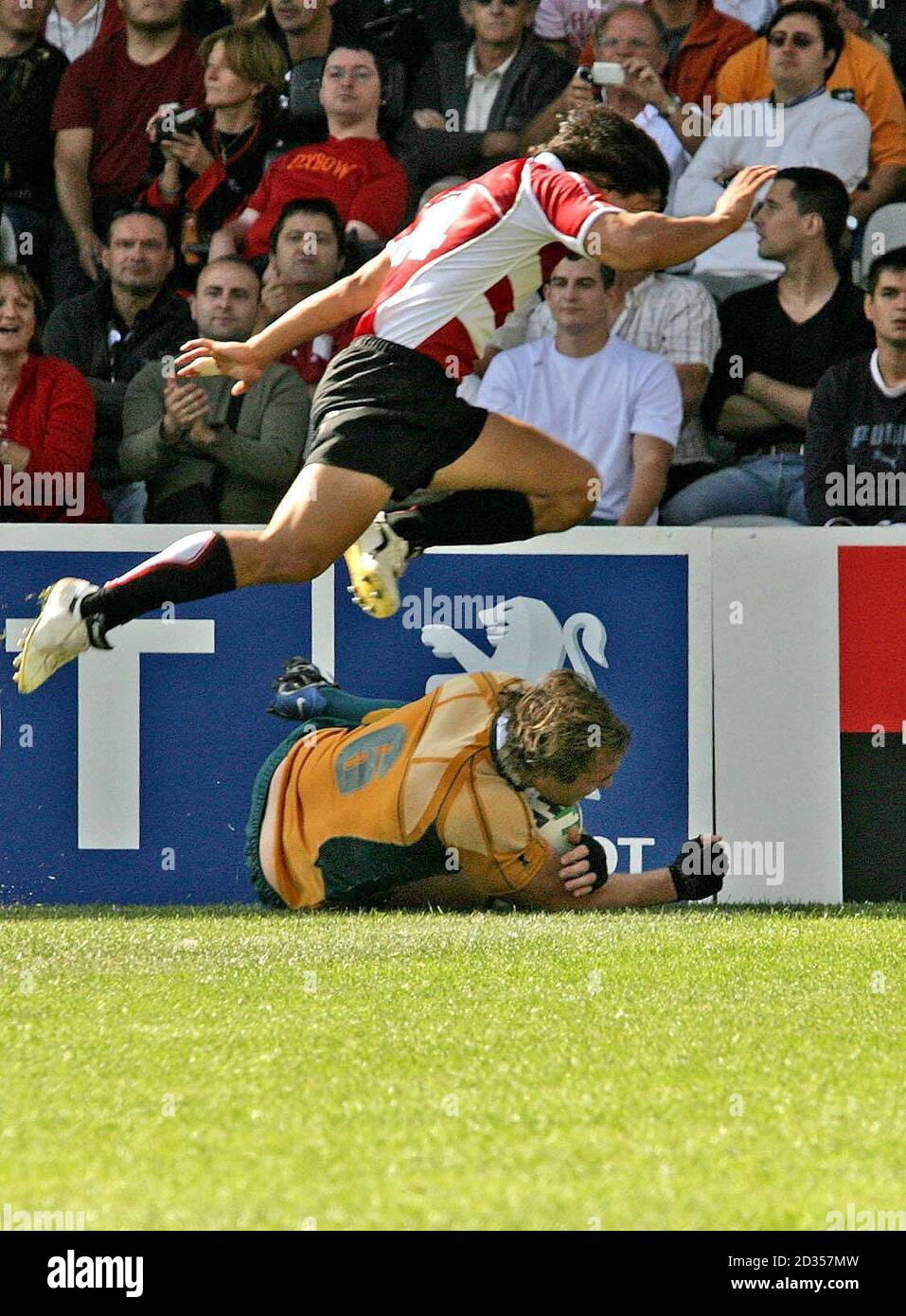 Australia's Rocky Elsom (bottom) scores the third try during the IRB ...