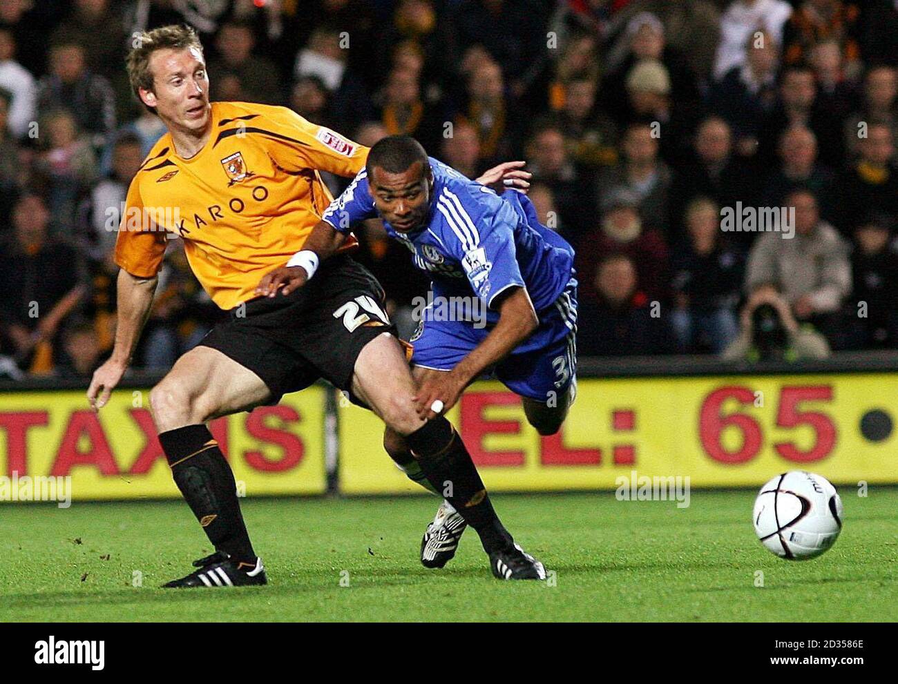 Hull's David Livermore (left) battles with Chelsea's Ashley Cole during ...