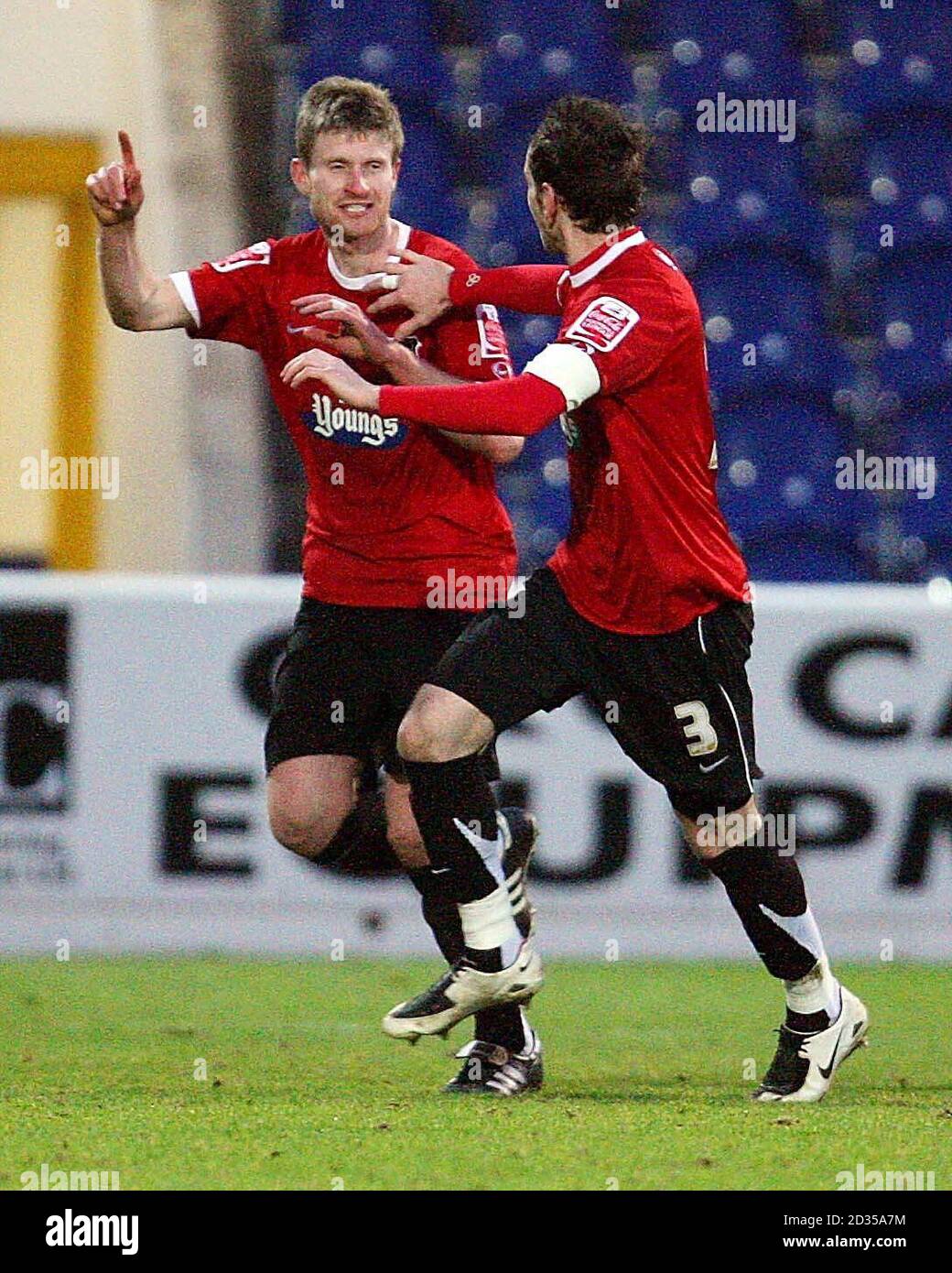 Grimsby Town's Danny Boshell (left) celebrates after scoring a penalty ...