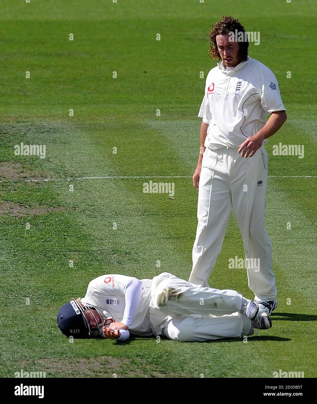 England's Ian Bell lies injured after being hit fielding during the 1st ...