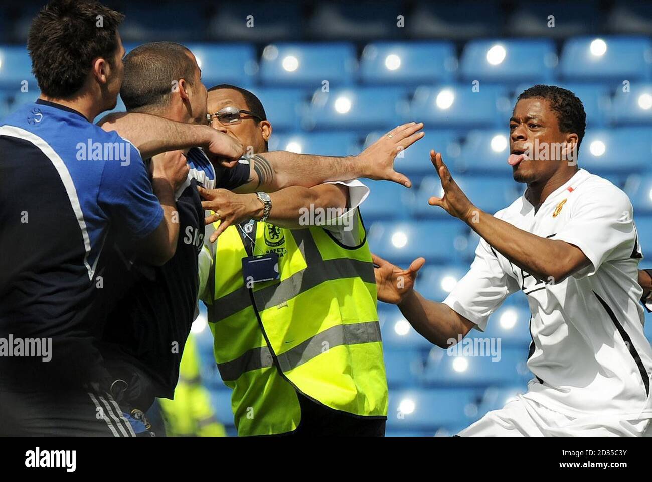 Manchester United's Patrice Evra scuffles with a Chelsea Groundsman ...