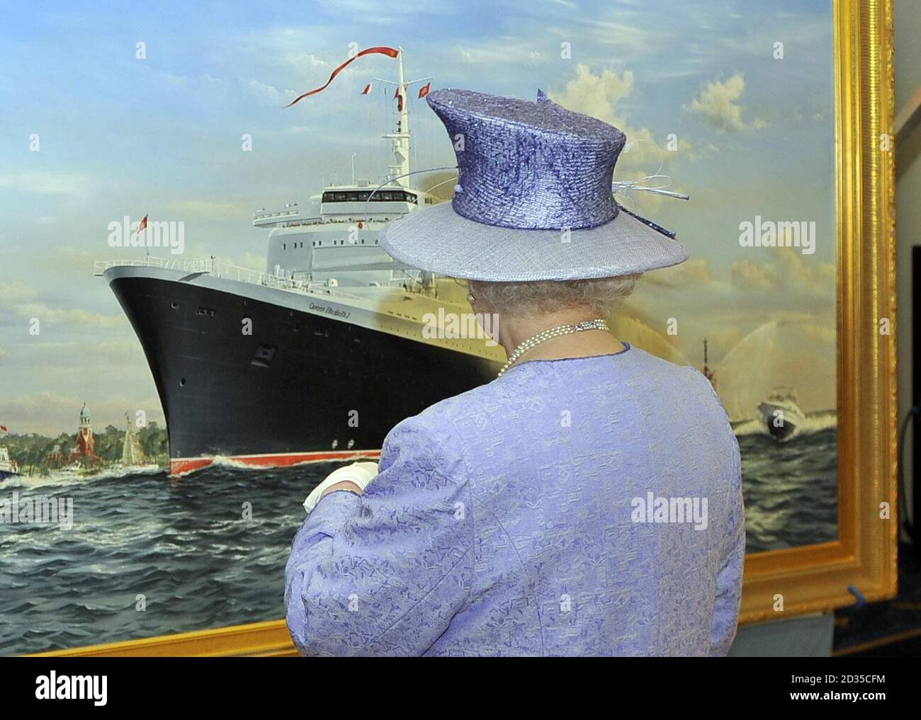 Britain's Queen Elizabeth II views the painting of the QEII which she ...