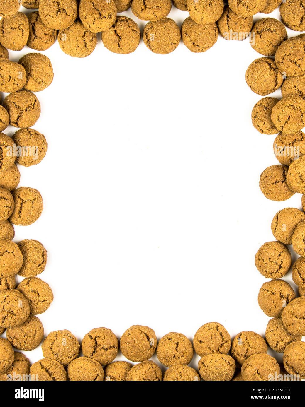 Frame of pepernoten from above on white background for annual ...