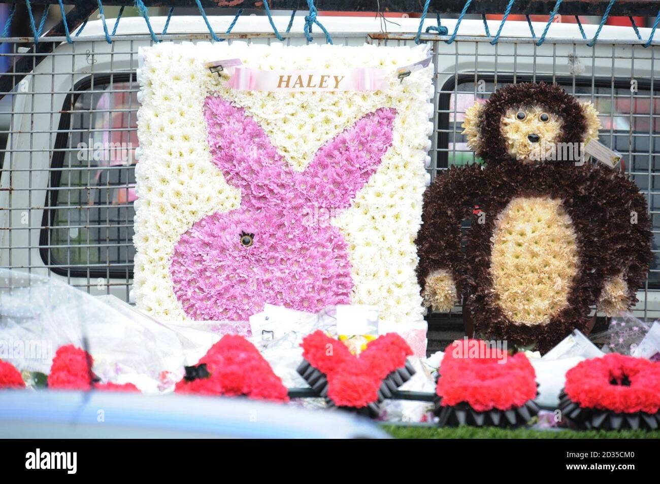 Floral tributes behind the coffin of Hayley Adamson, 16, as it arrives ...