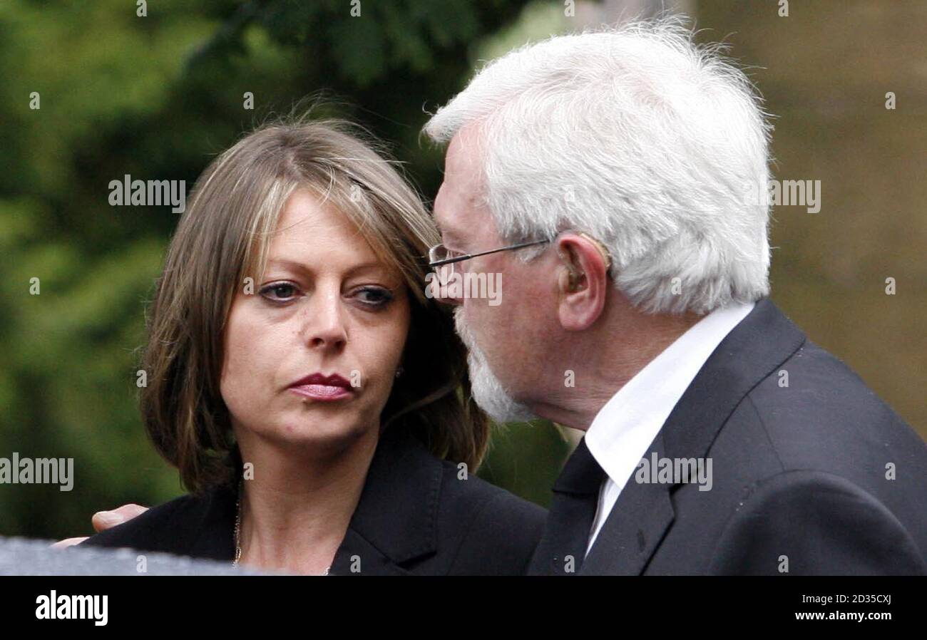 Lyn Philcox is comforted at the funeral of her children, Amy and Owen ...