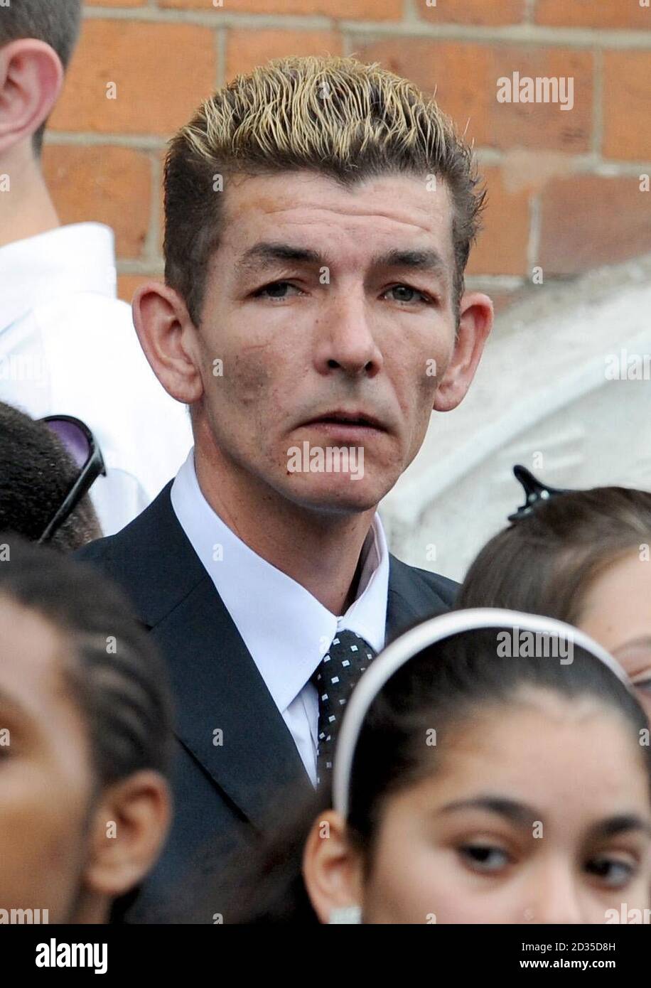 A mourner leaves the funeral of Ben Kinsella, at the St. John's the ...